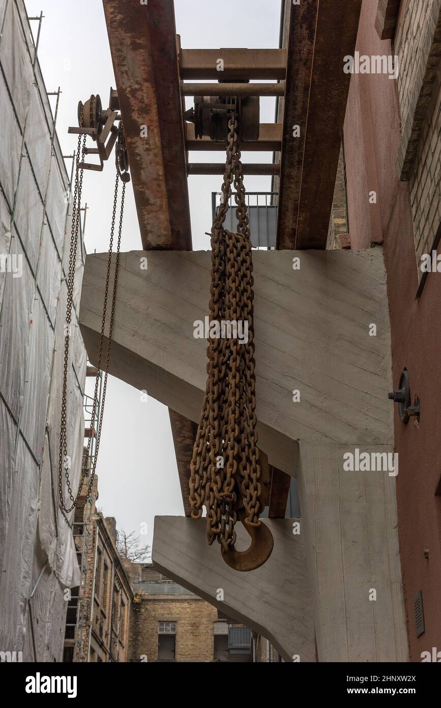 Chain hoist for lifting weights in an old factory Stock Photo - Alamy