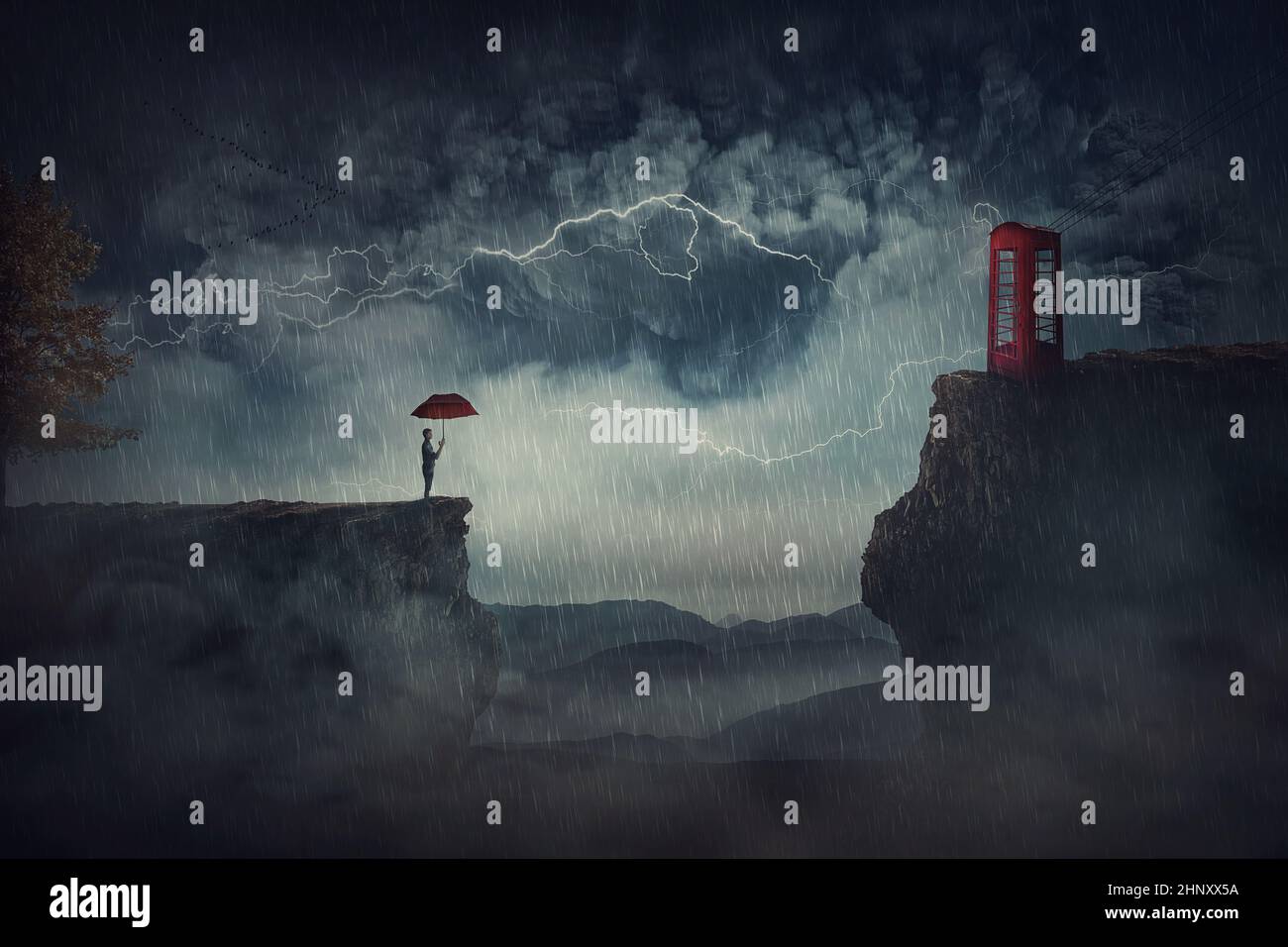 Person with an umbrella under the storm, stands on the edge of a cliff ...