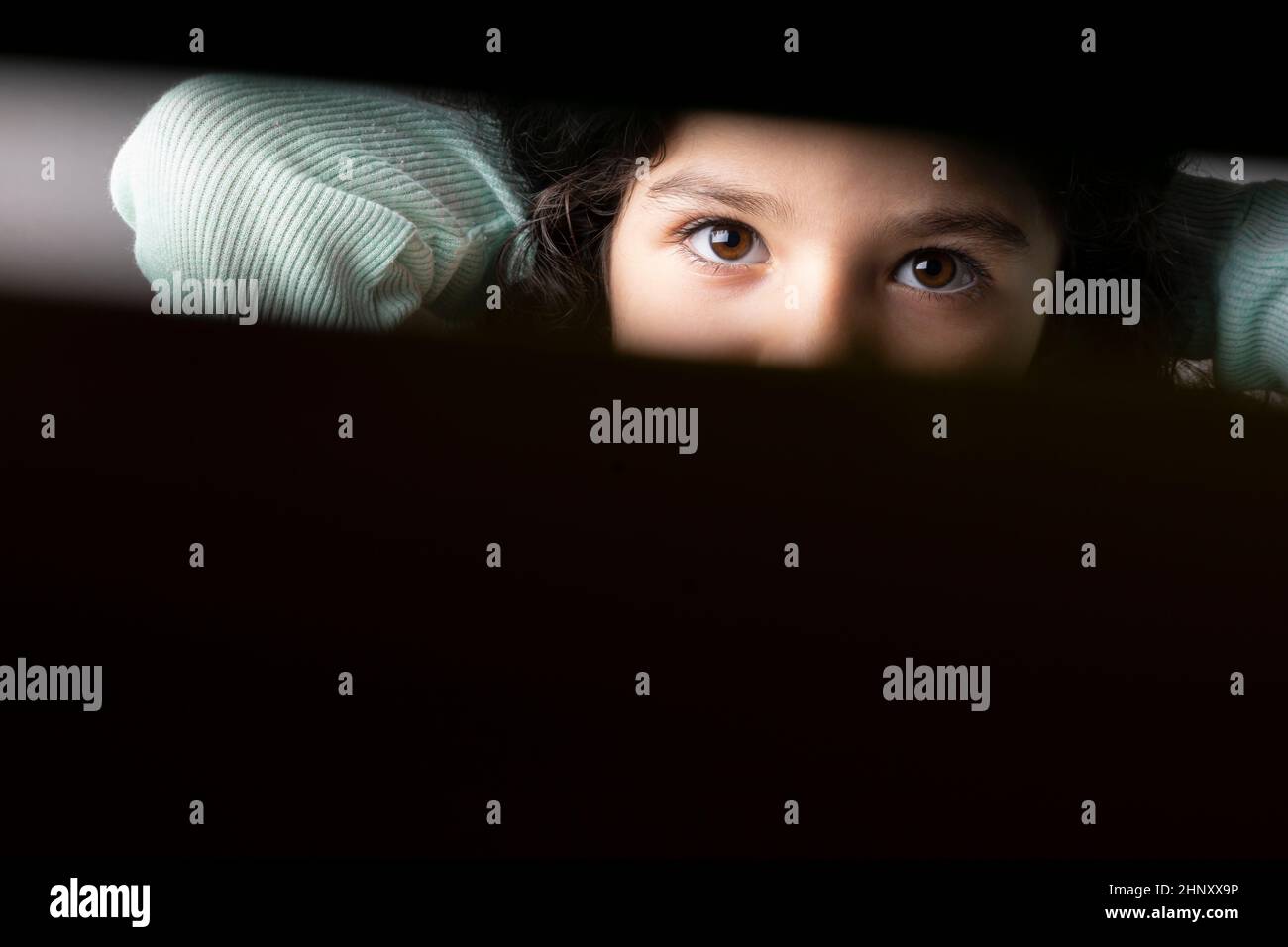 Little girl portrait behind black curtain looking in camera Stock Photo ...