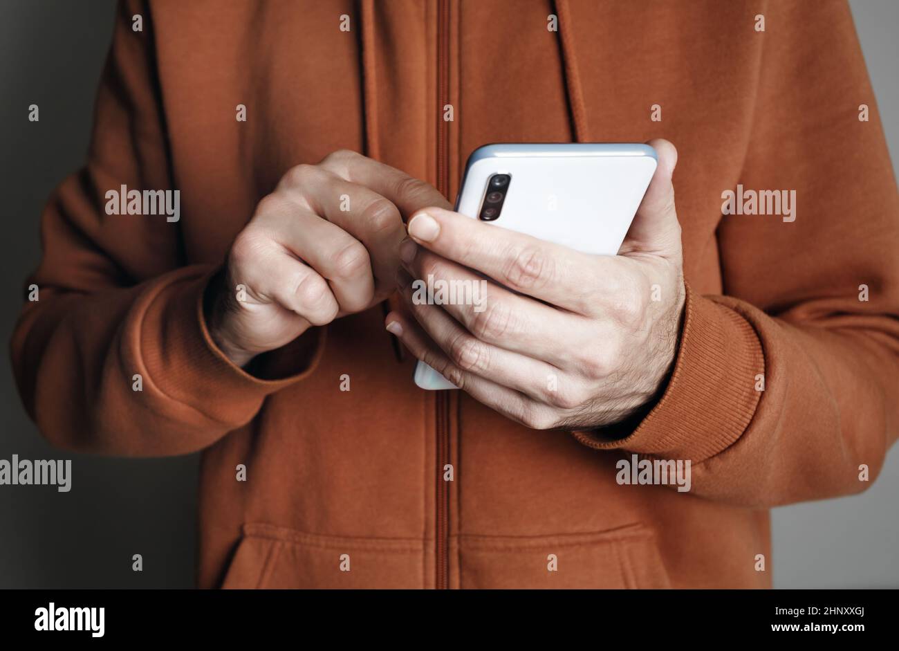Smartphone in male hands. Man uses mobile phone Stock Photo - Alamy