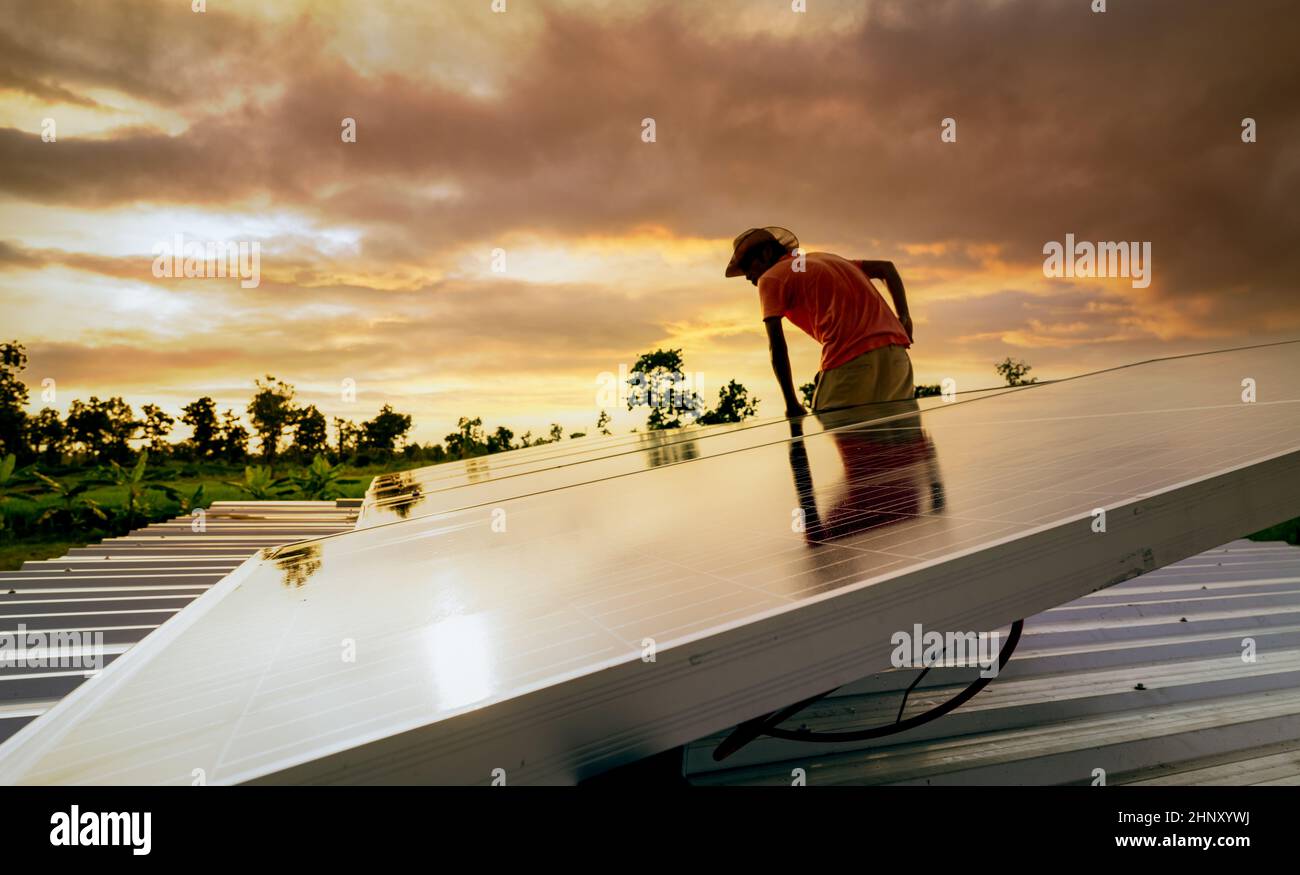 Man checking solar panel on roof for safety. Solar panel or ...