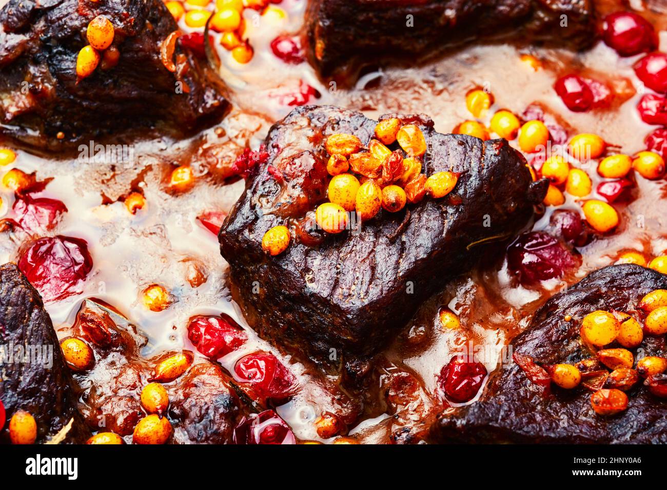 Beef stewed in sea buckthorn and cranberries.Food background Stock ...