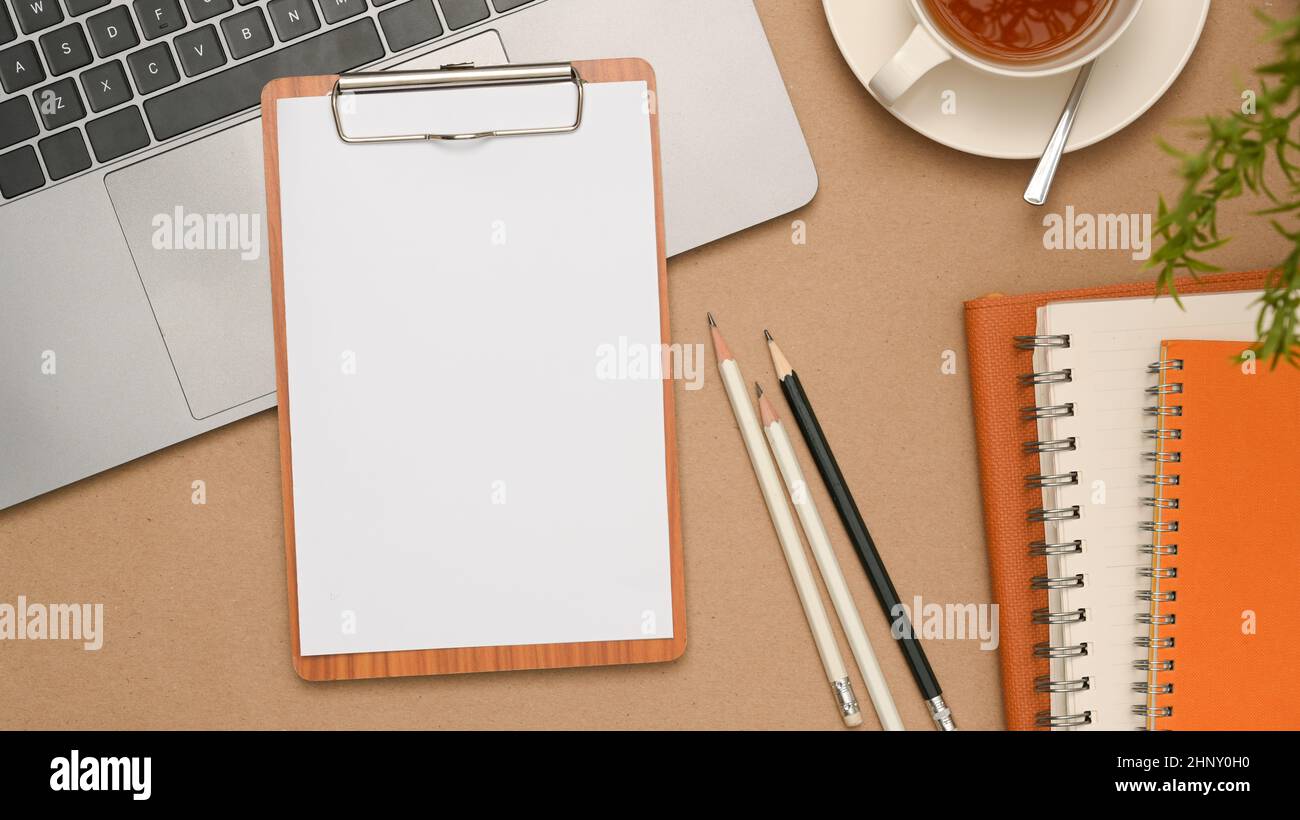 Minimal office table workspace with empty paper on wooden clipboard ... Minimal office table workspace with empty paper on wooden clipboard ...