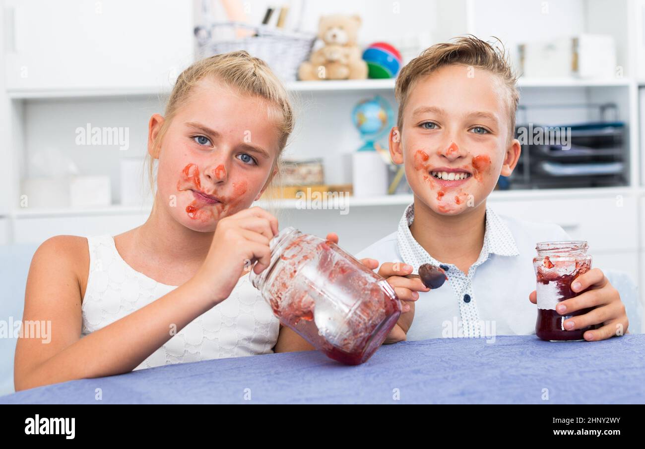 Girl and boy are eating jam Stock Photo - Alamy