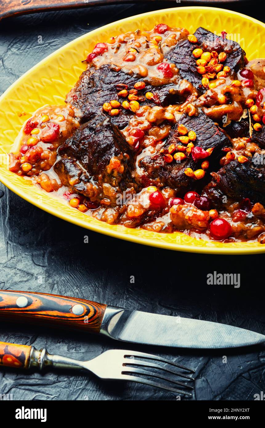 Pieces of beef stewed in sea buckthorn and cranberries Stock Photo - Alamy