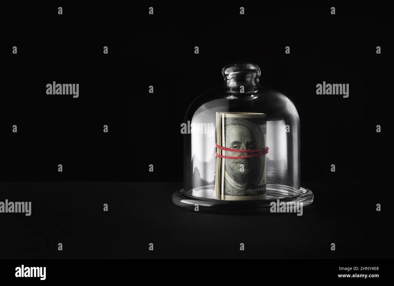 Pack of dollars under glass cap. Money under the glass cover. Copy ...