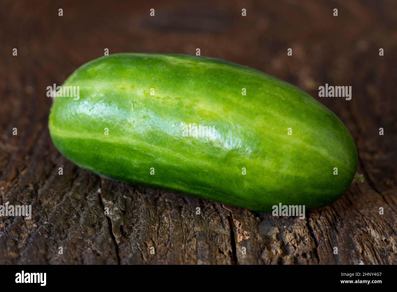 organic cucumber on dark wood Stock Photo - Alamy