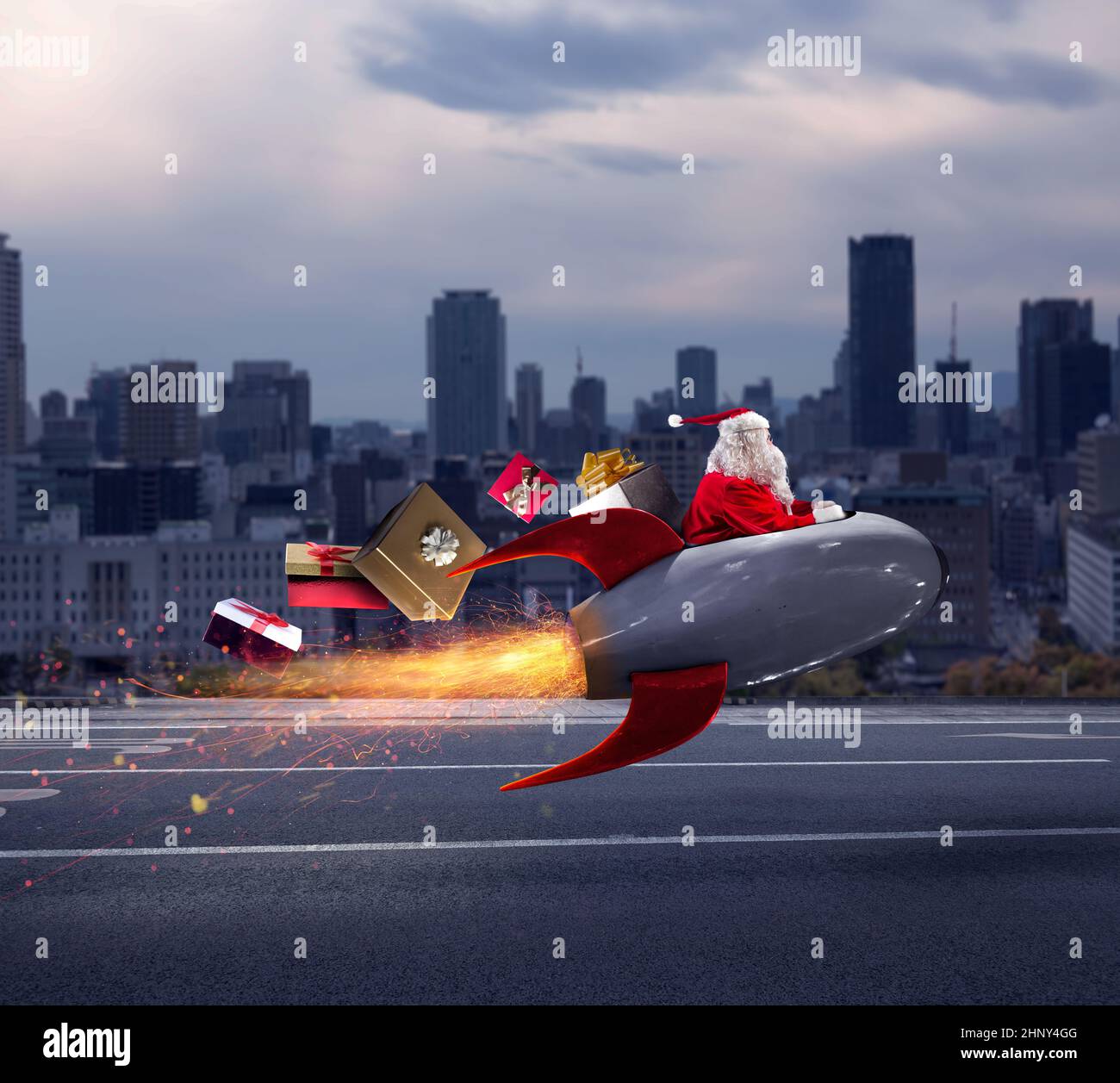 Santa claus delivers gifts with a fast rocket Stock Photo - Alamy