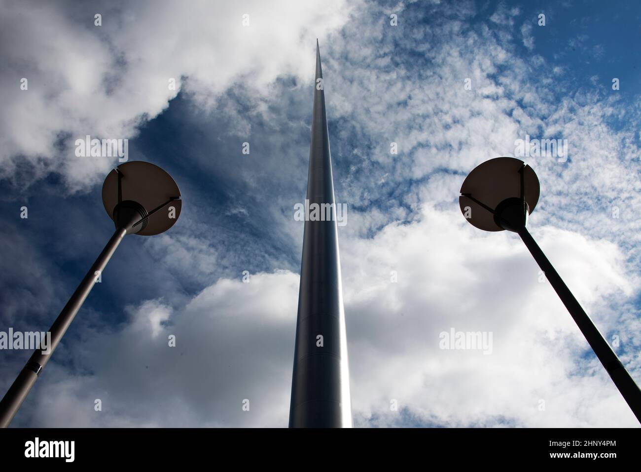 The Spire of Dublin with converging street lights blue sky and clouds ...
