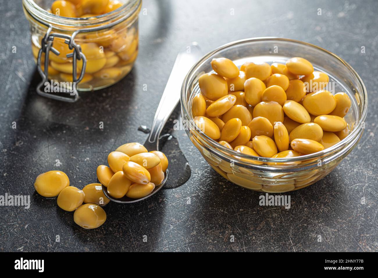 Pickled yellow Lupin Beans in bowl on kitchen table Stock Photo - Alamy