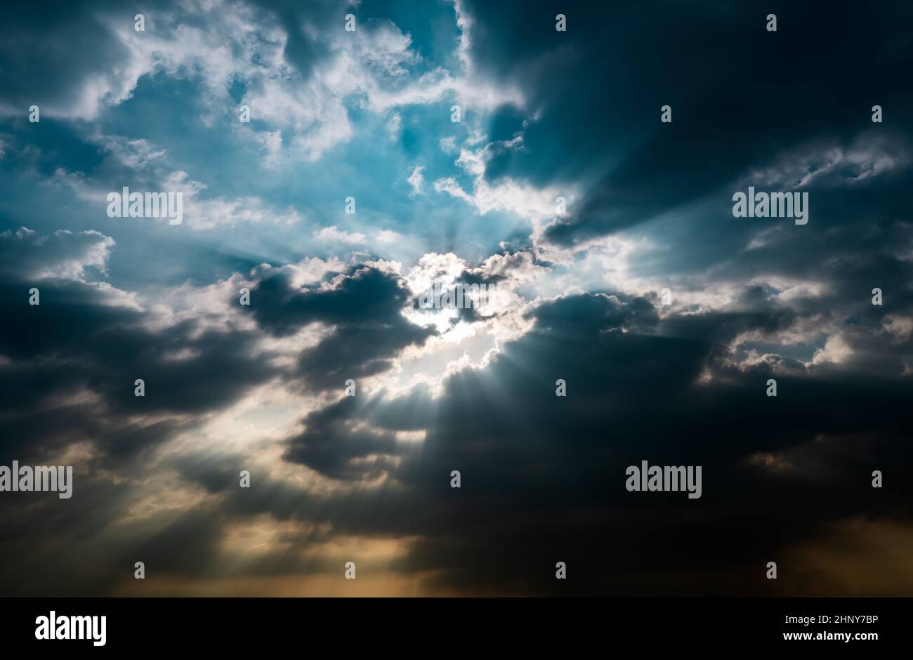 God light. Dark cloudy sky with sun beam. Sun rays through black clouds ...