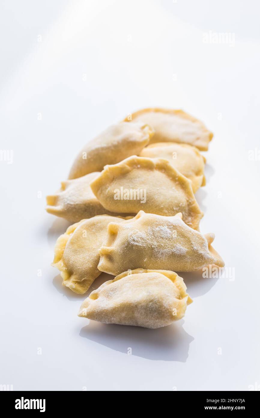 Pierogi or Vareniki, raw frozen dumplings isolated on white background ...