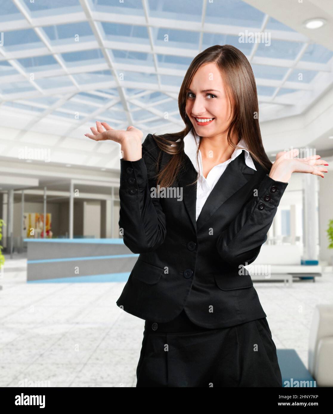 Smiling business woman in corporate building Stock Photo - Alamy