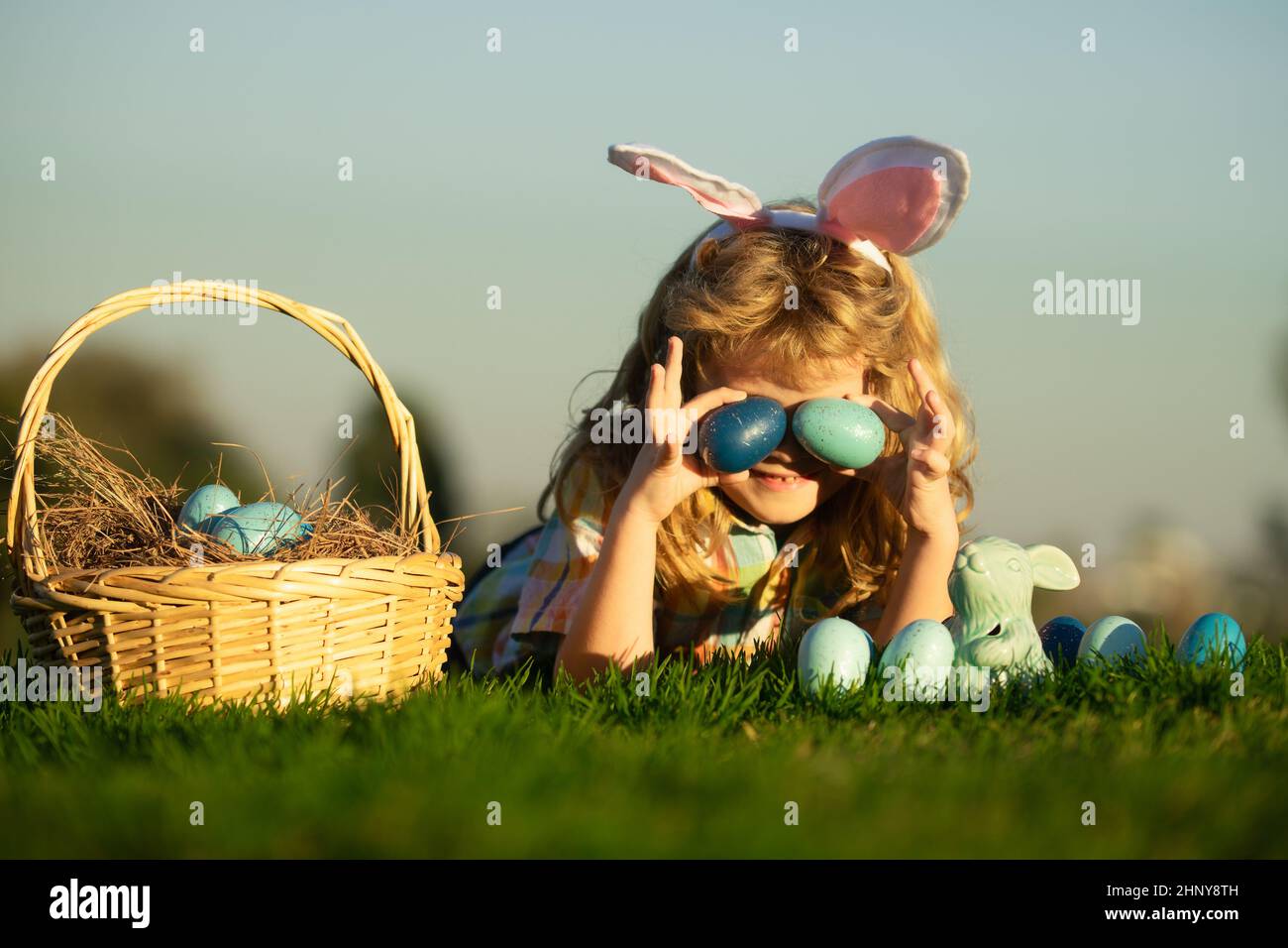 Easter egg hunt in garden. Children playing in field, hunting easter ...