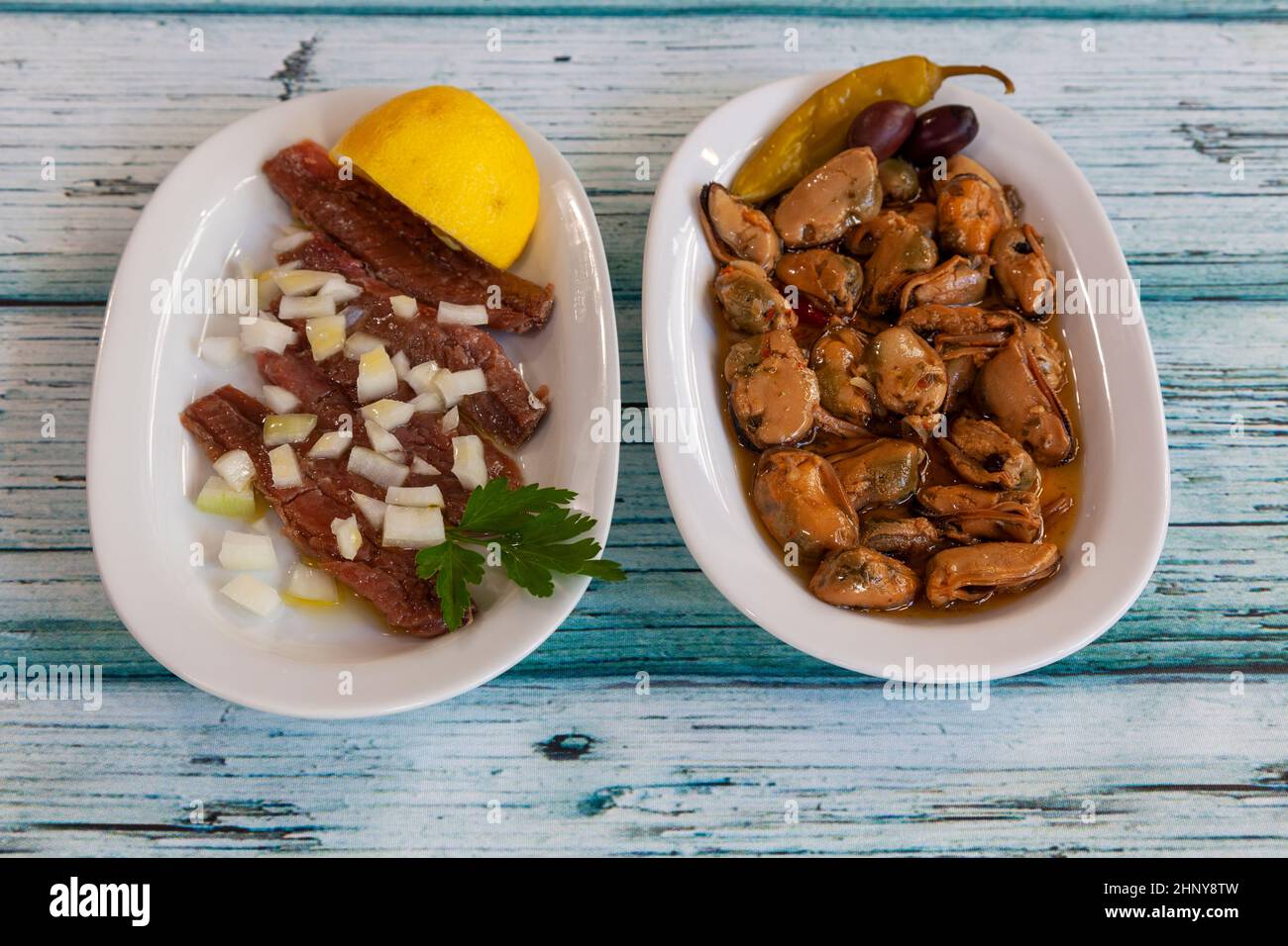 Greek meze anchovies with oil and mussels sganaki Stock Photo - Alamy