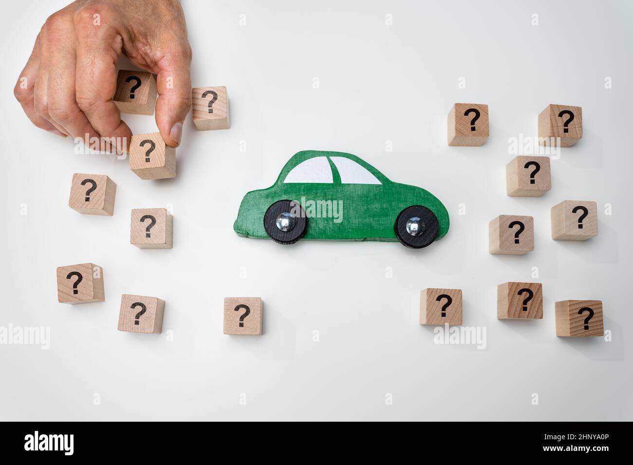 Person Hand Holding Question Mark Next To Car Model Stock Photo - Alamy