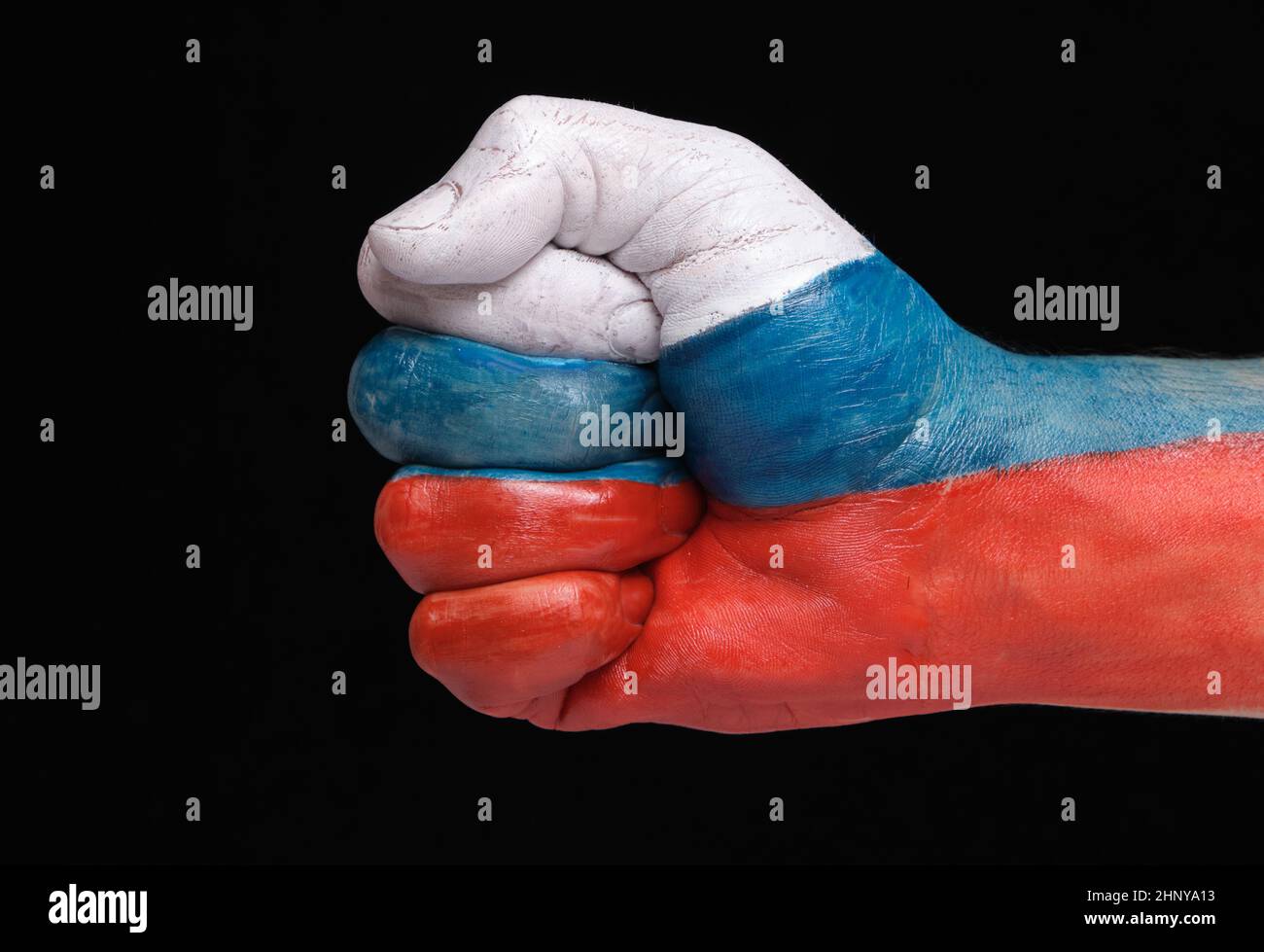 Fist hand is painted in colors flag Russian Federation, on a black ...