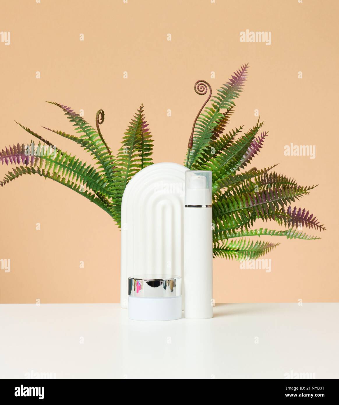white plastic bottle and jar for cosmetics on a white table. Packaging ...