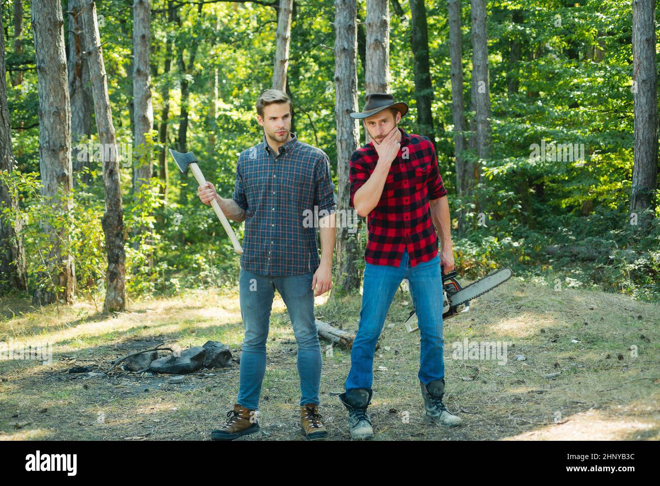 Lumberjack man in red checkered shirt with axe on wooden forest ...