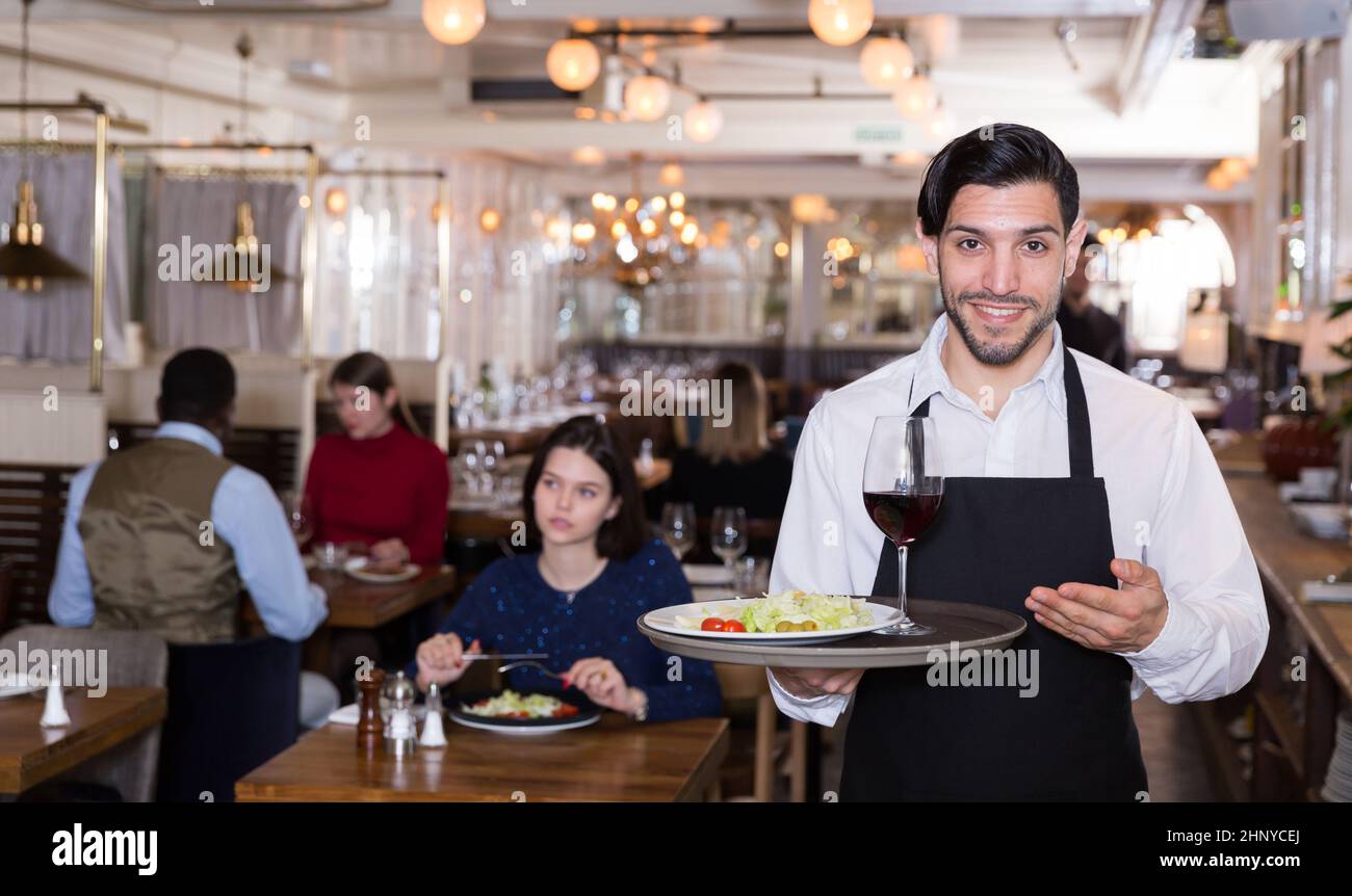 Smiling waiter with serving tray Stock Photo - Alamy
