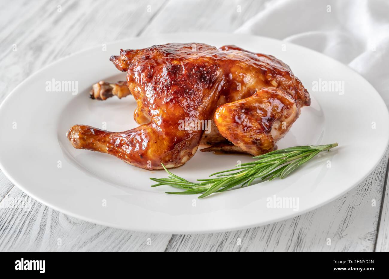 Roasted chicken on the white serving plate Stock Photo - Alamy