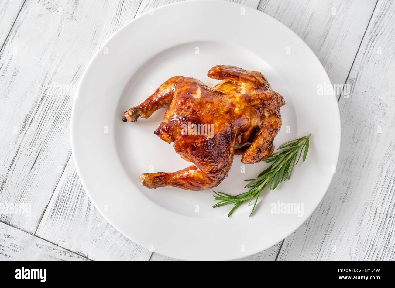 Roasted chicken on the white serving plate Stock Photo - Alamy