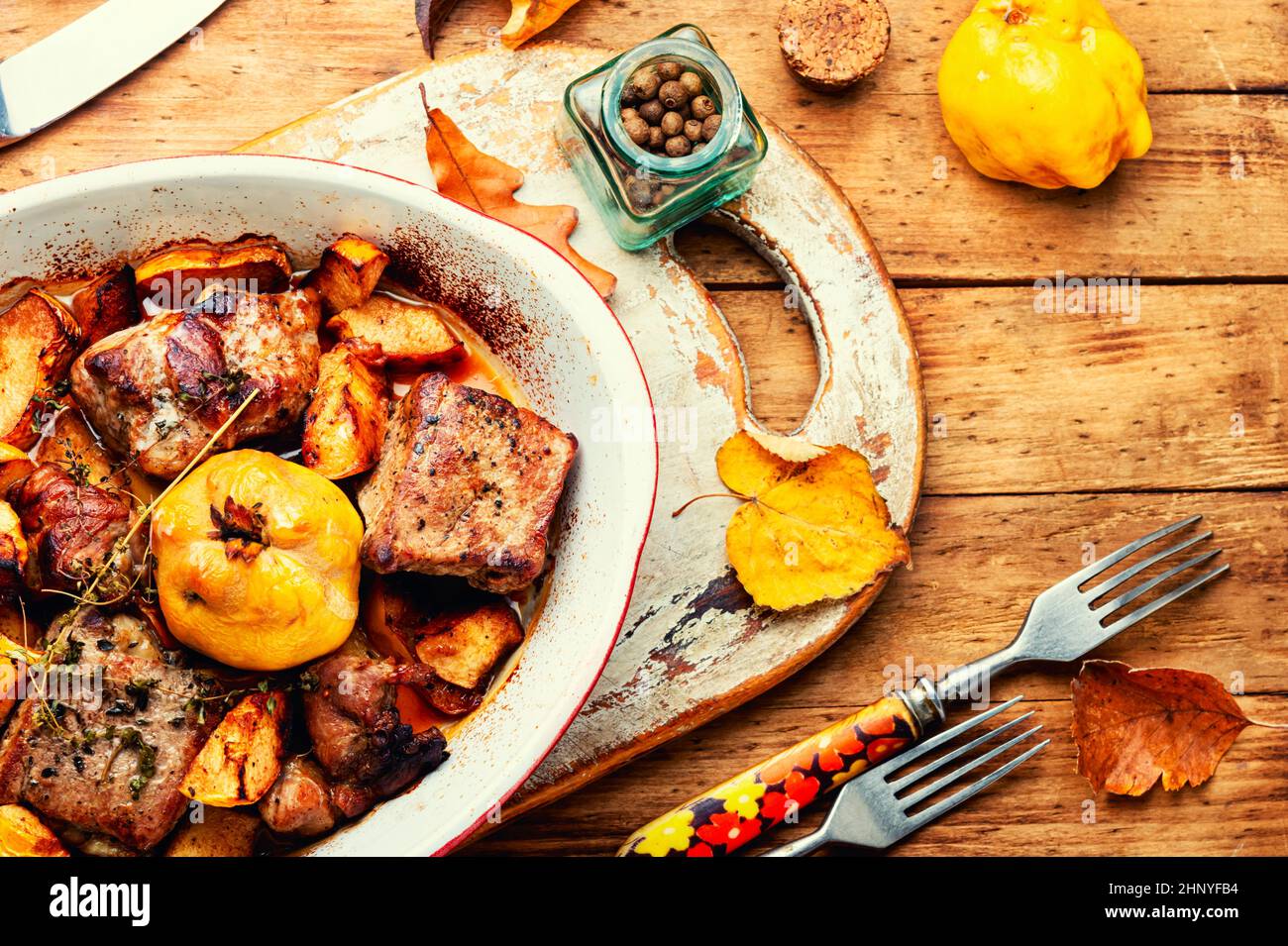 Delicious baked meat with aromatic autumn quince Stock Photo - Alamy