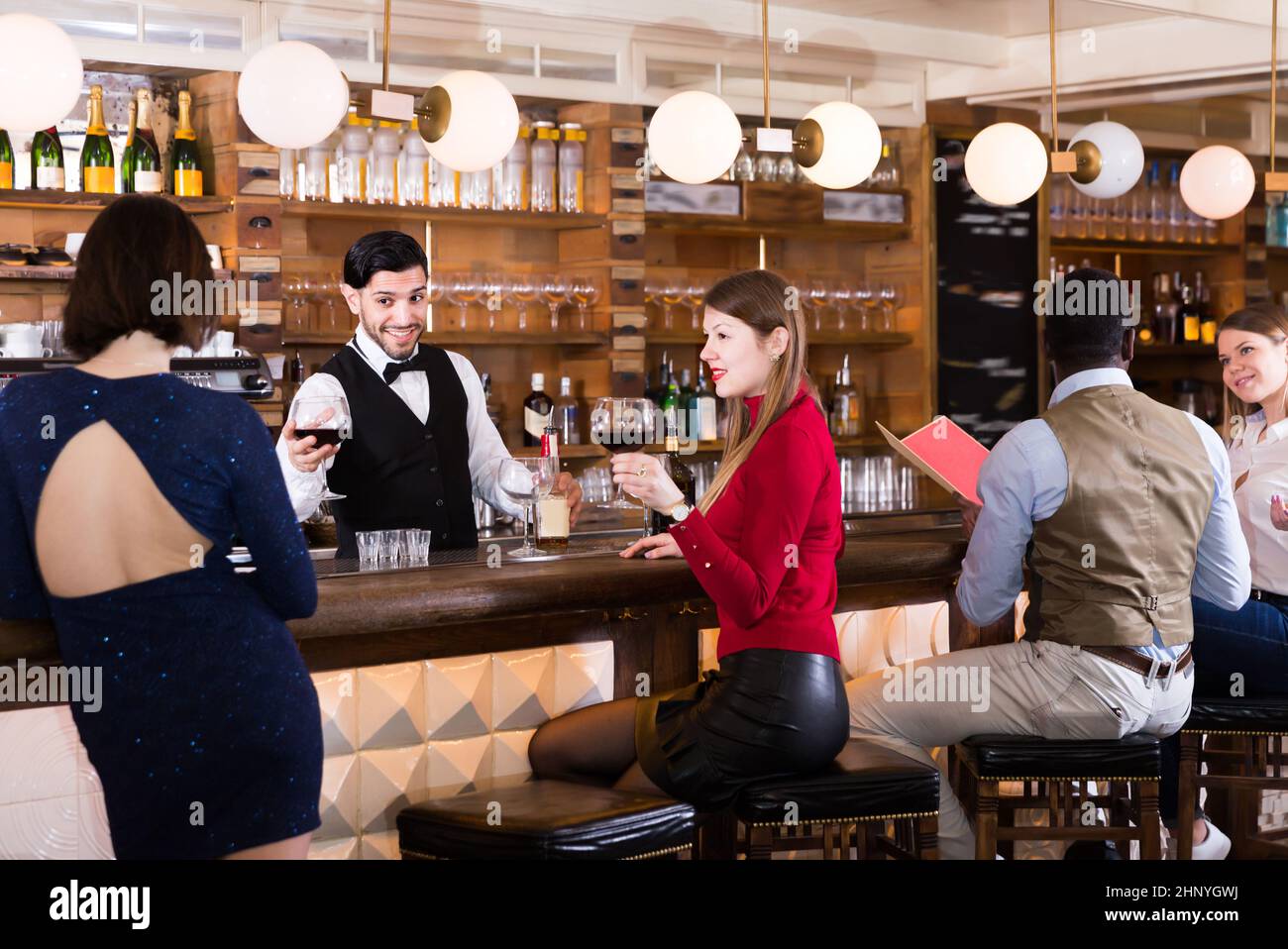 Cheerful people are relaxing near bar counter Stock Photo - Alamy