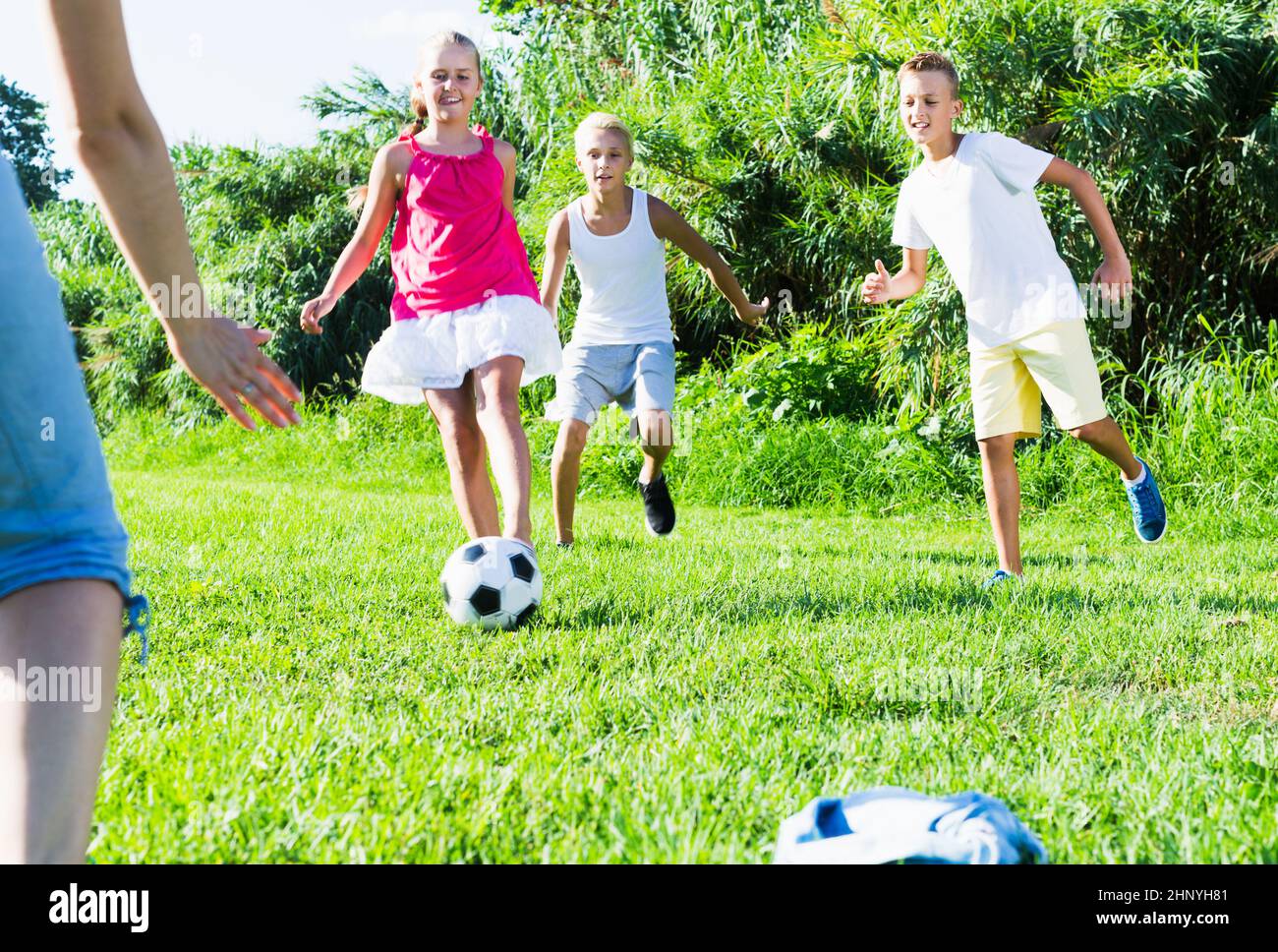 Group of laughing children playing football Stock Photo - Alamy