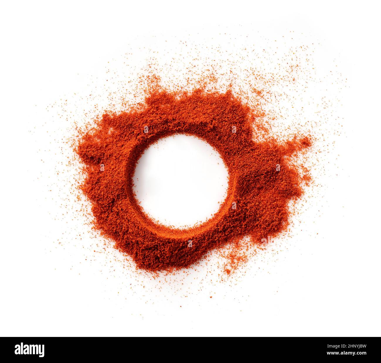 A round frame made of red pepper powder on a white background. View ...