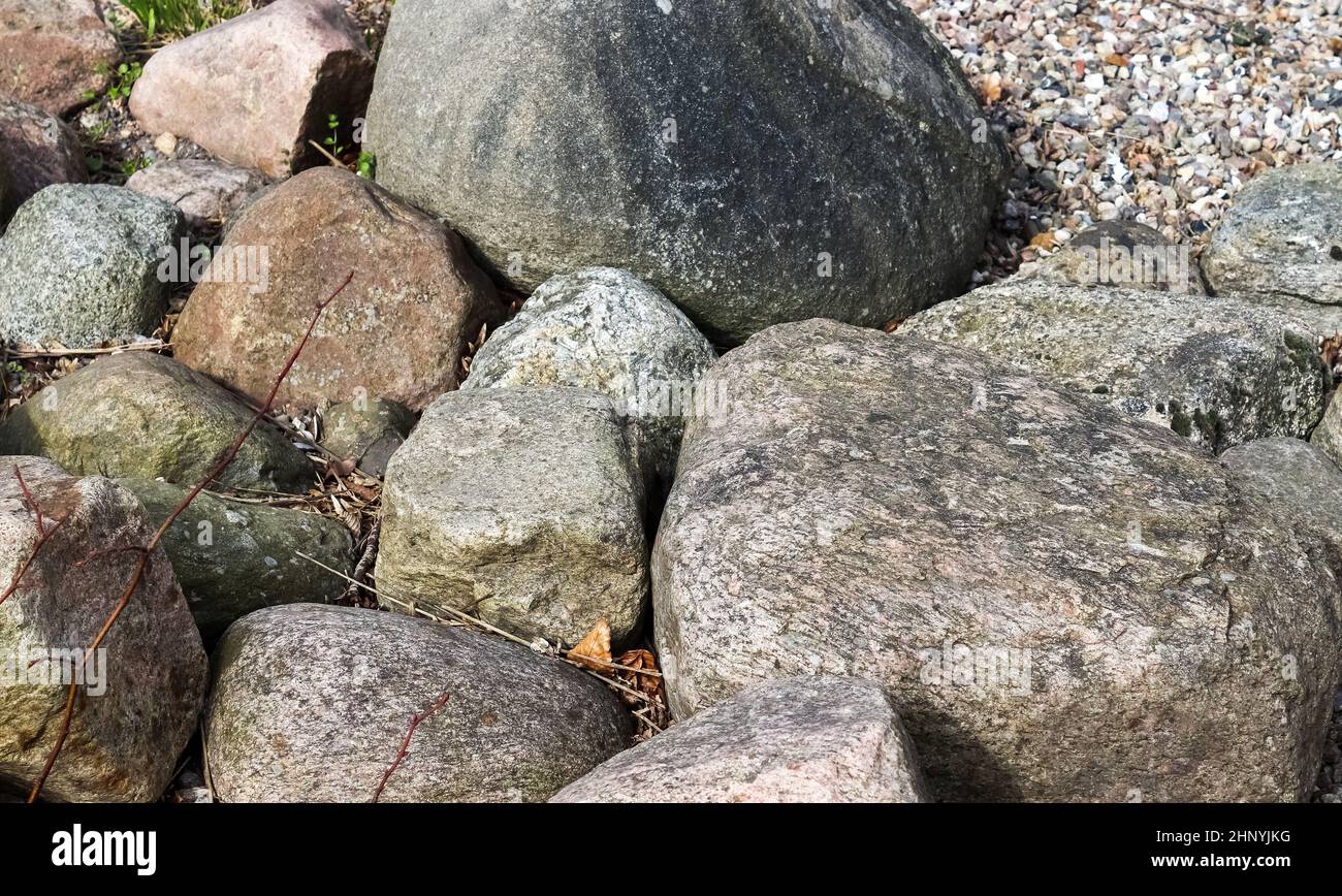 Detailed close up view on pebbles and stones on a gravel ground texture ...