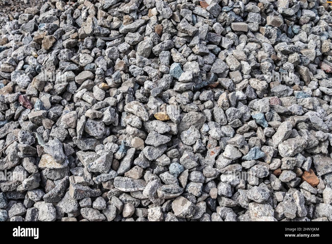 Detailed close up view on pebbles and stones on a gravel ground texture ...