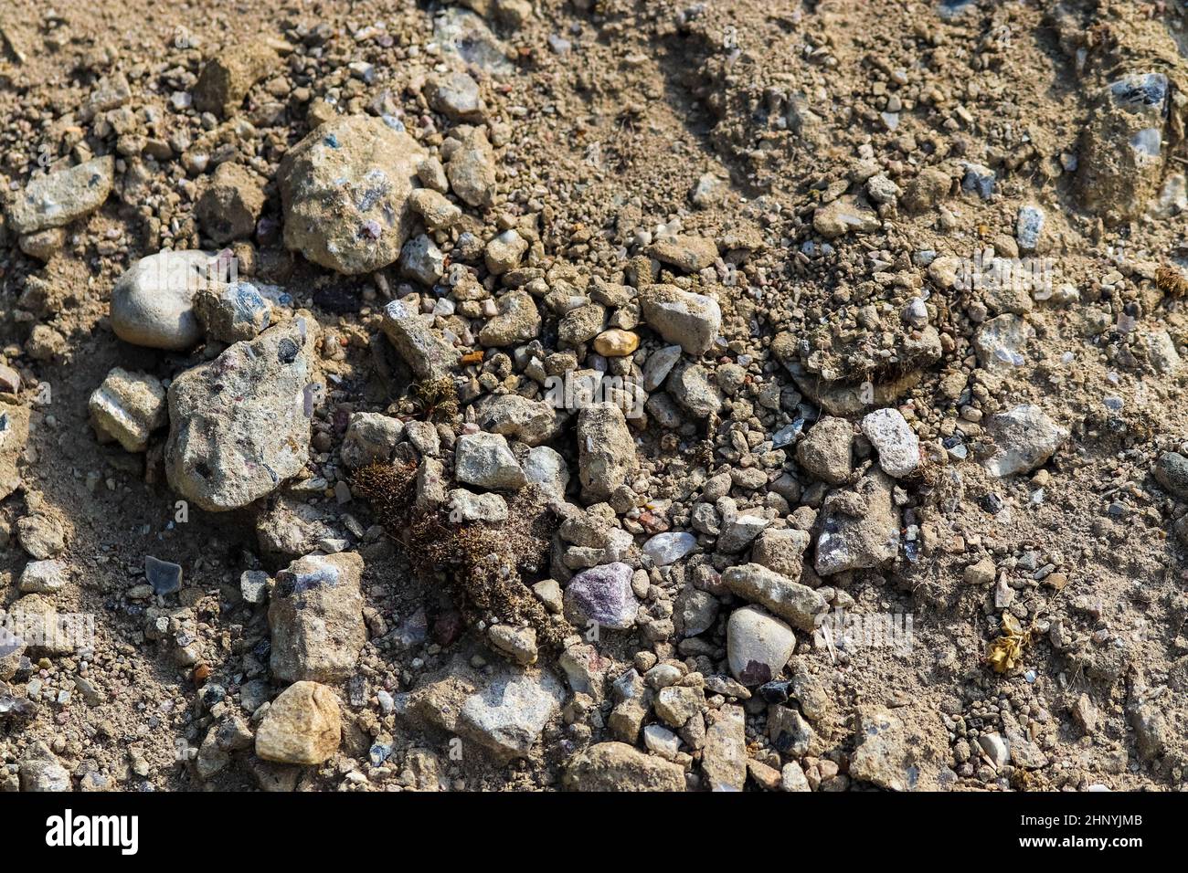 Detailed close up view on pebbles and stones on a gravel ground texture ...