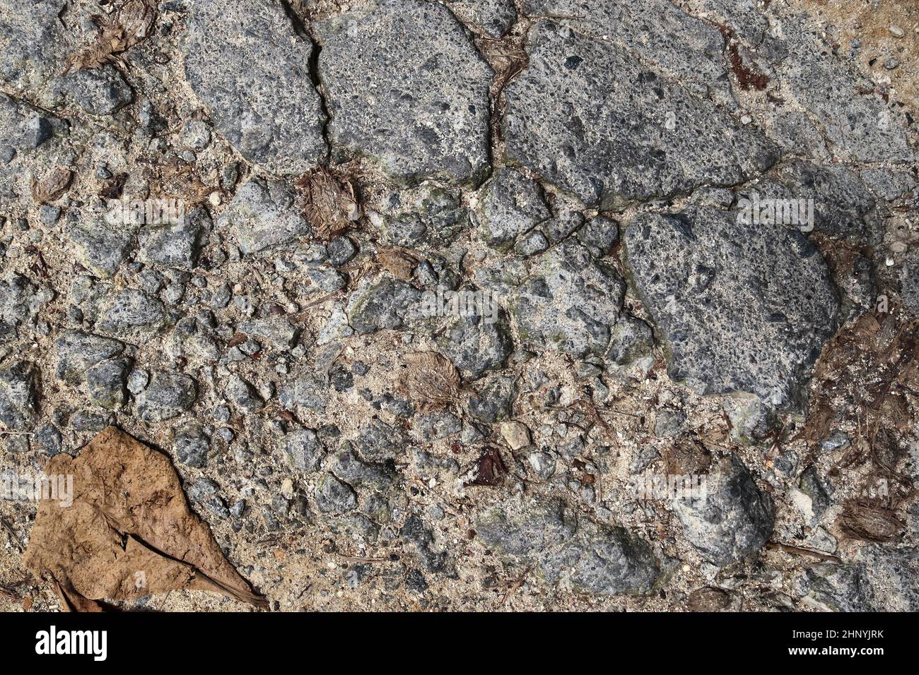 Detailed close up view on pebbles and stones on a gravel ground texture ...
