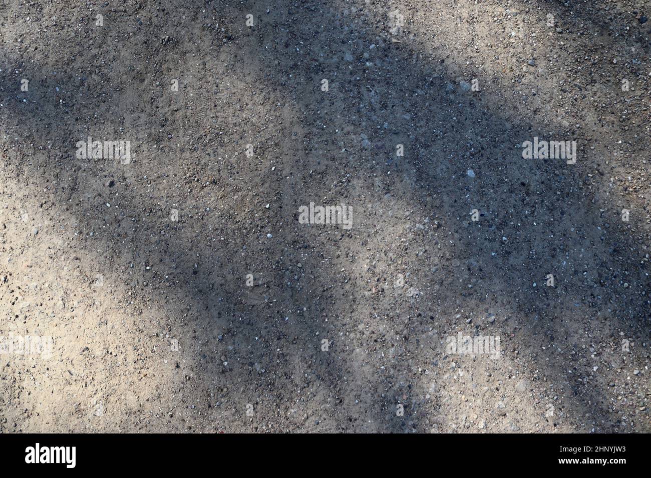 Detailed close up view on pebbles and stones on a gravel ground texture ...