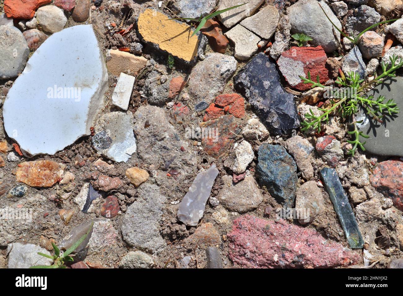 Detailed close up view on pebbles and stones on a gravel ground texture ...