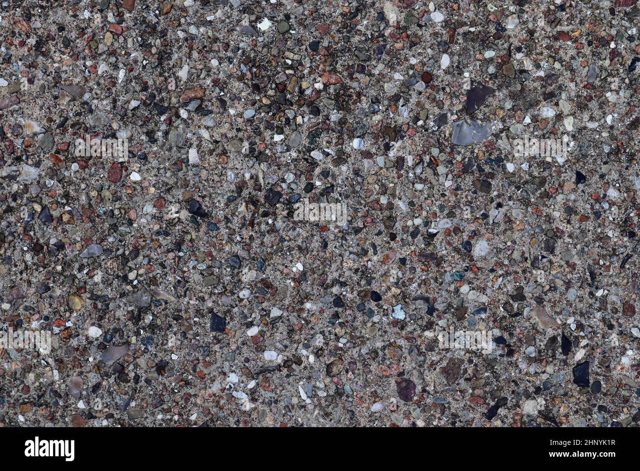 Detailed close up view on pebbles and stones on a gravel ground texture ...