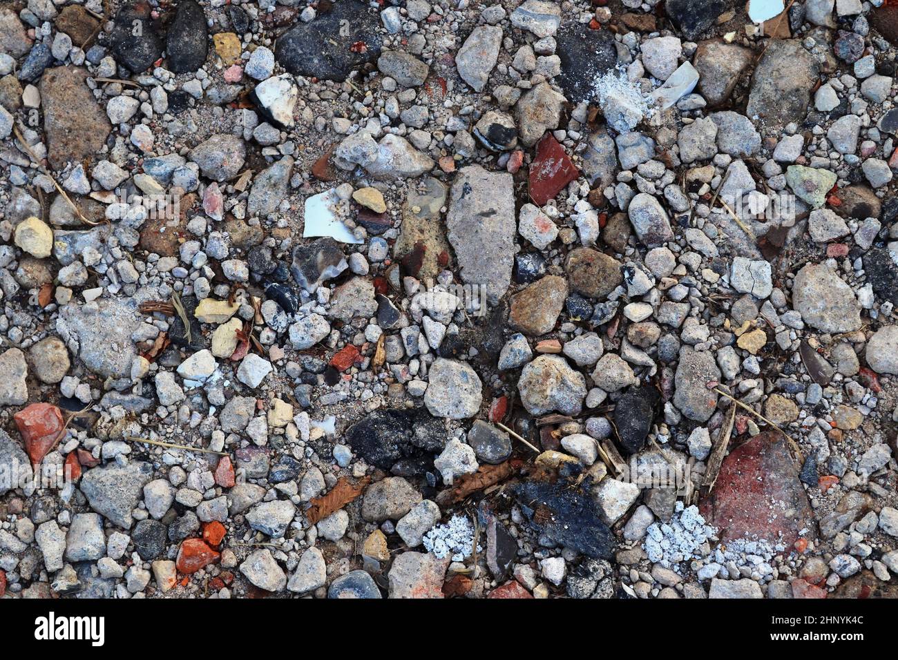 Detailed close up view on pebbles and stones on a gravel ground texture ...