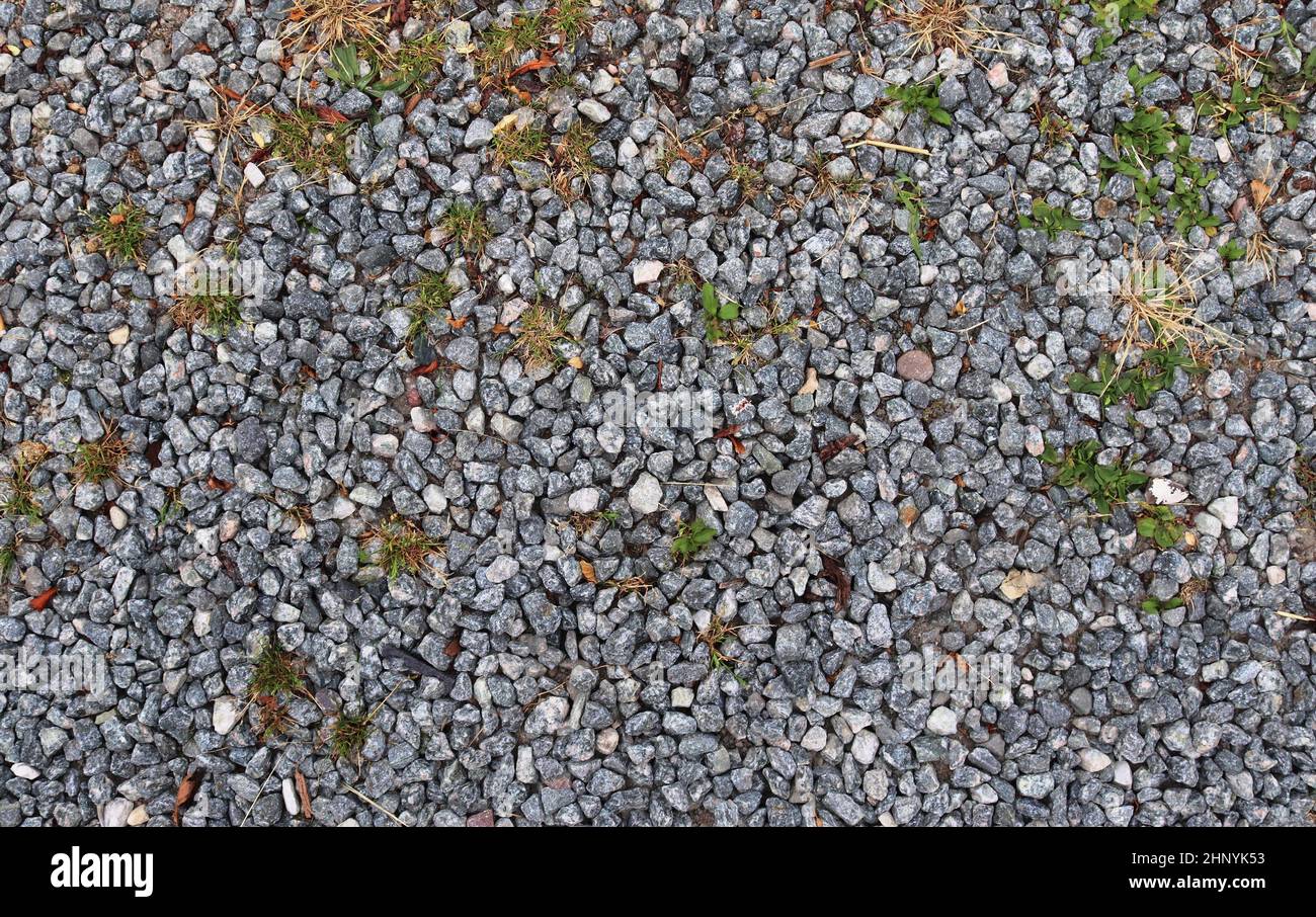Detailed close up view on pebbles and stones on a gravel ground texture ...