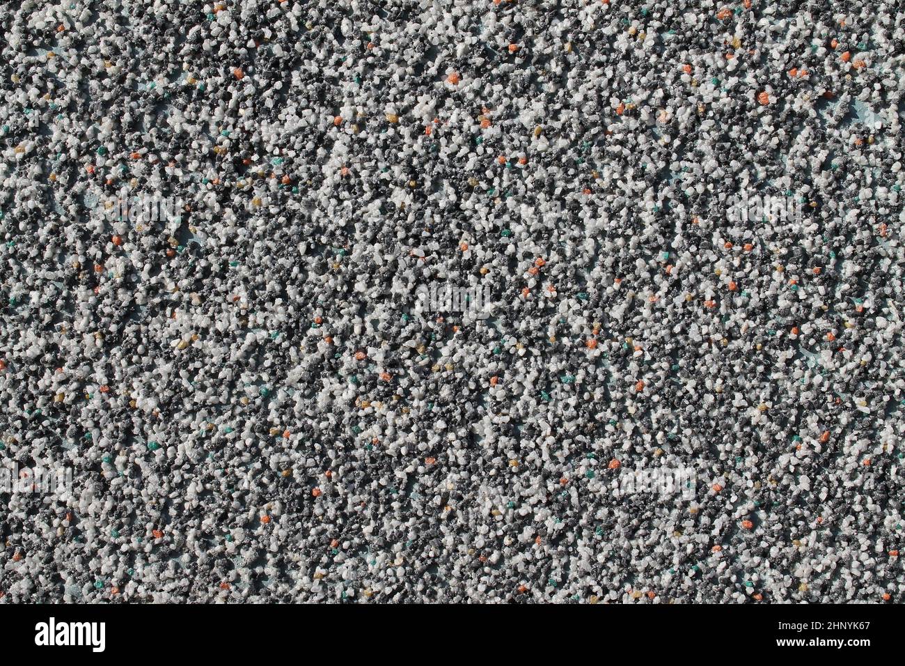 Detailed close up view on pebbles and stones on a gravel ground texture ...