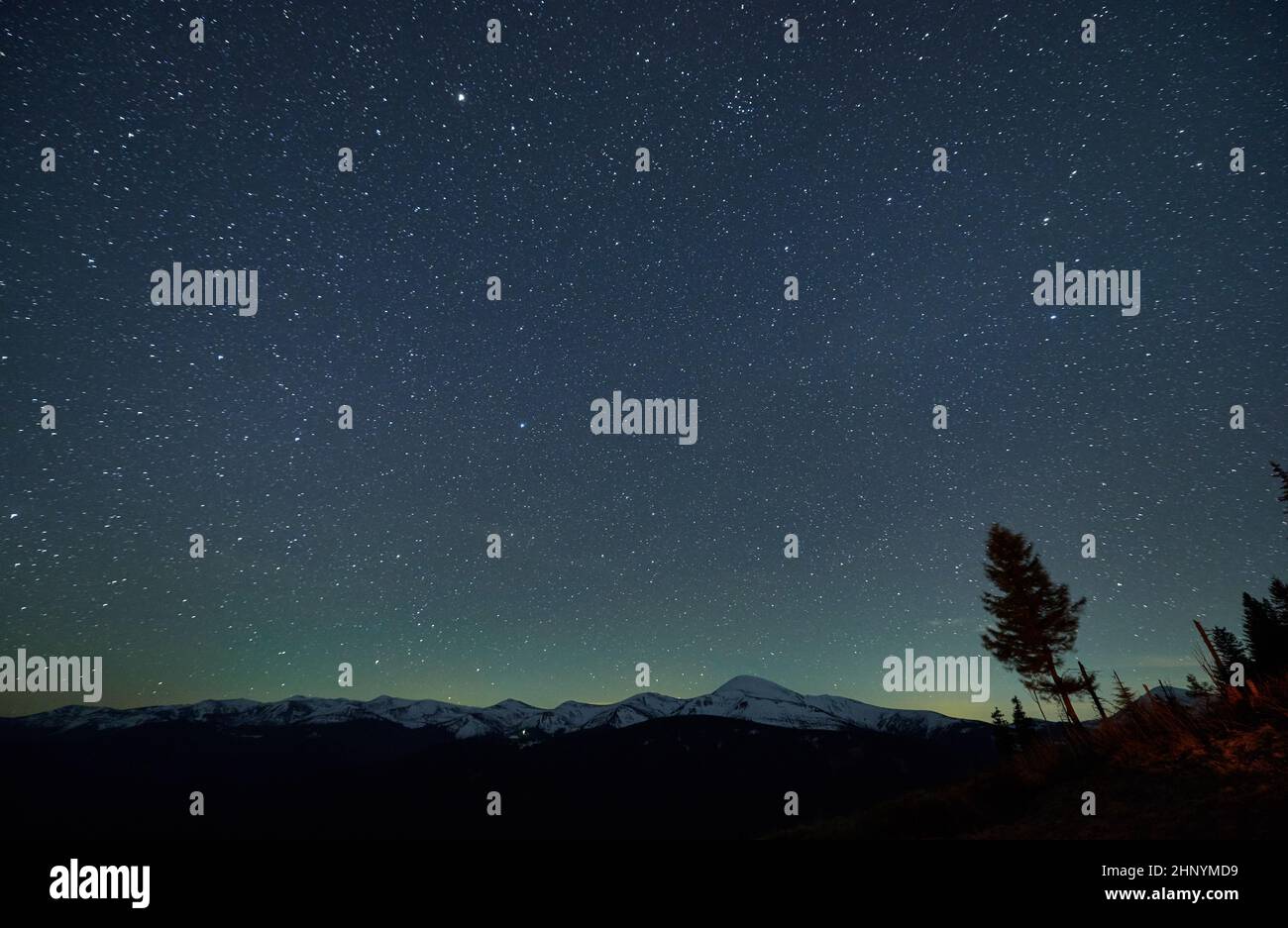 Magic starry night in the mountains. Beautiful winter landscape of snow ...