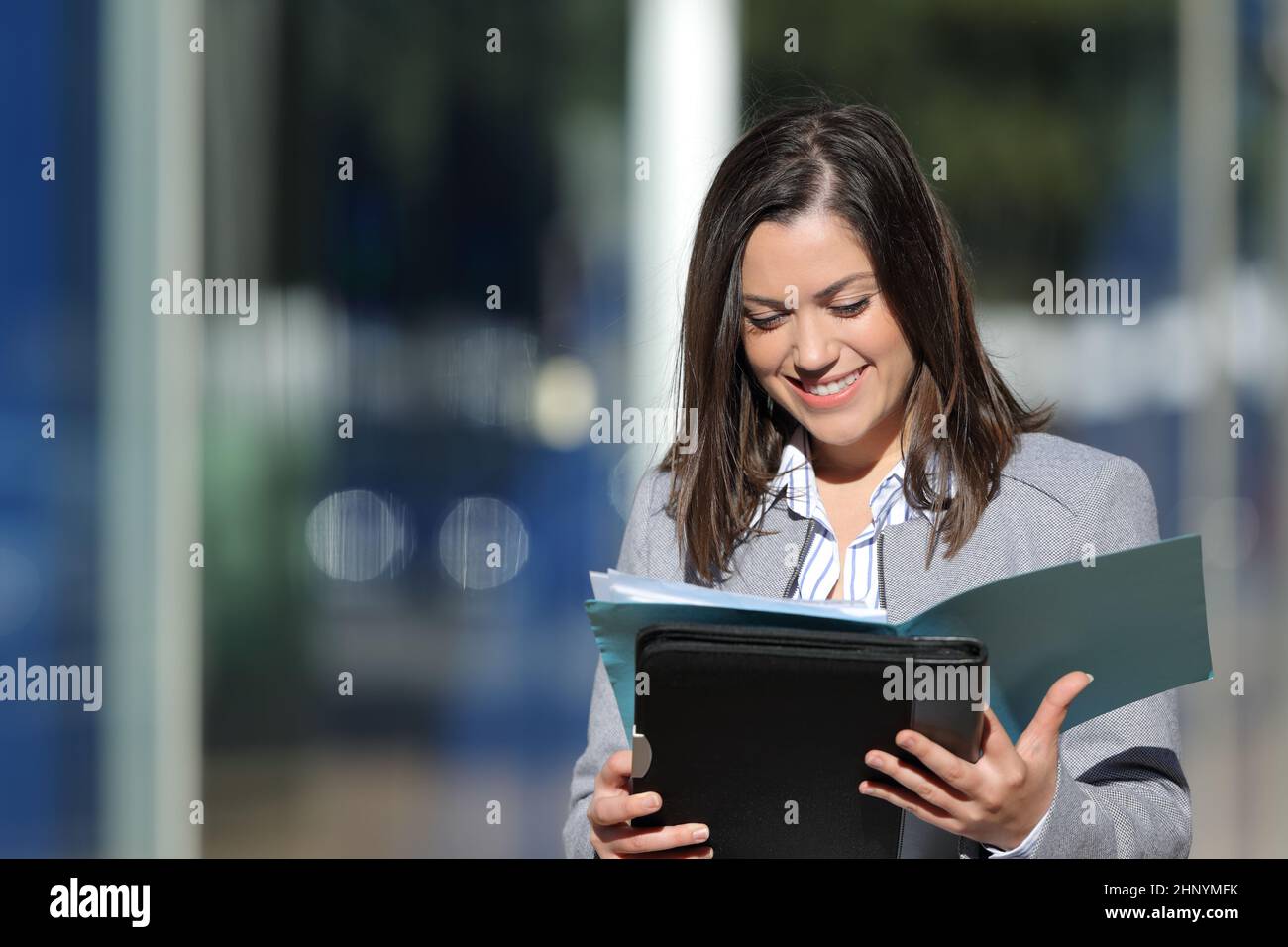 Happy executive reading paper hi-res stock photography and images - Alamy