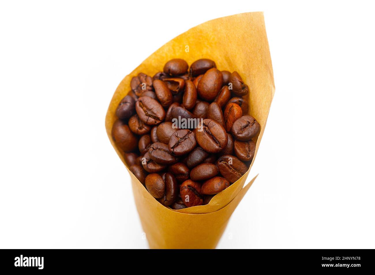 espresso coffee beans on a paper cone cornucopia over white background ...