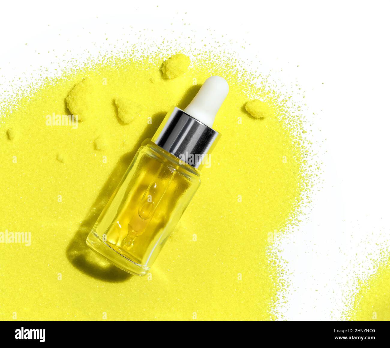 Yellow cosmetic liquid (oil) in Dropper Bottle place on Potassium ...