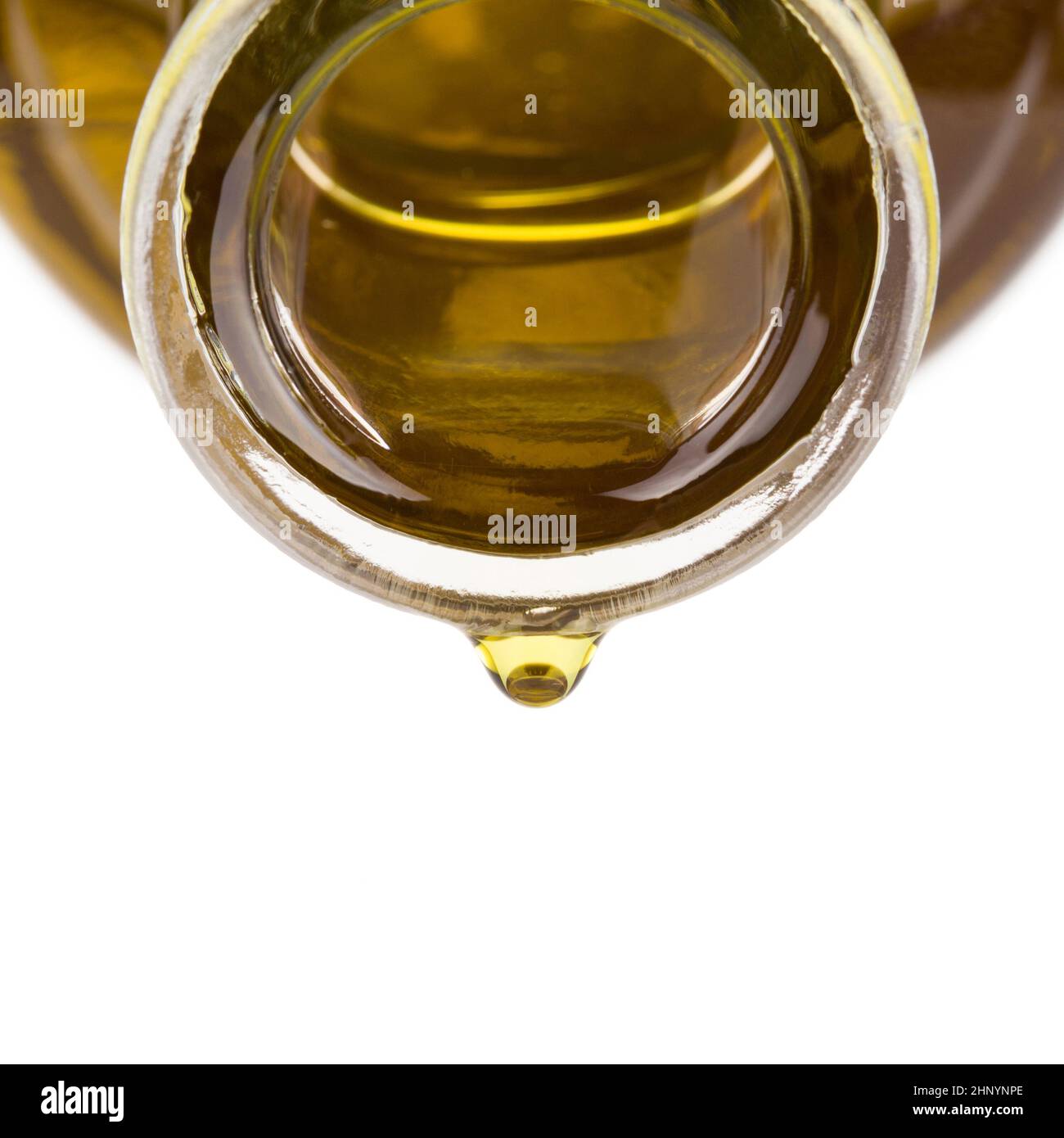 Oil drop on a bottle. Oil pouring from a bottle Stock Photo - Alamy