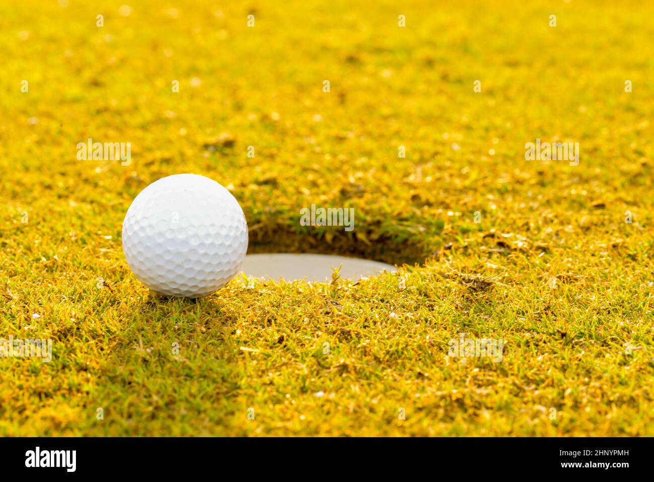 Golf ball and hole background Stock Photo - Alamy