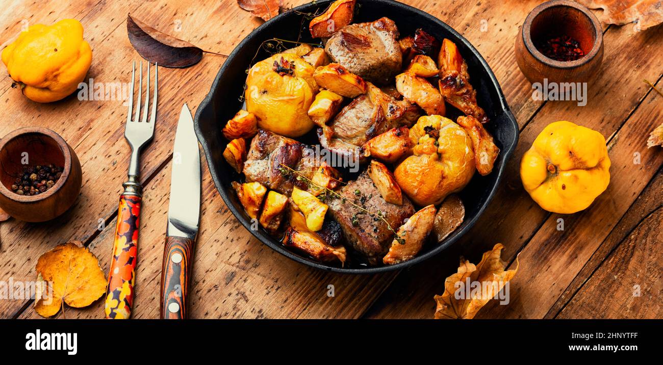 Fried pork meat with autumn quince.Autumnal food Stock Photo - Alamy