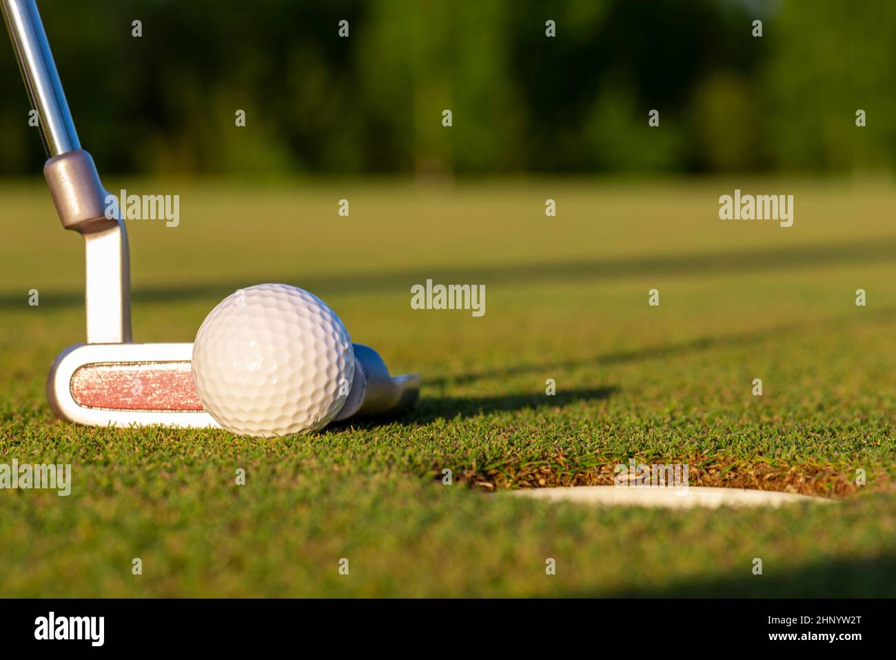 Golf ball and hole background Stock Photo - Alamy