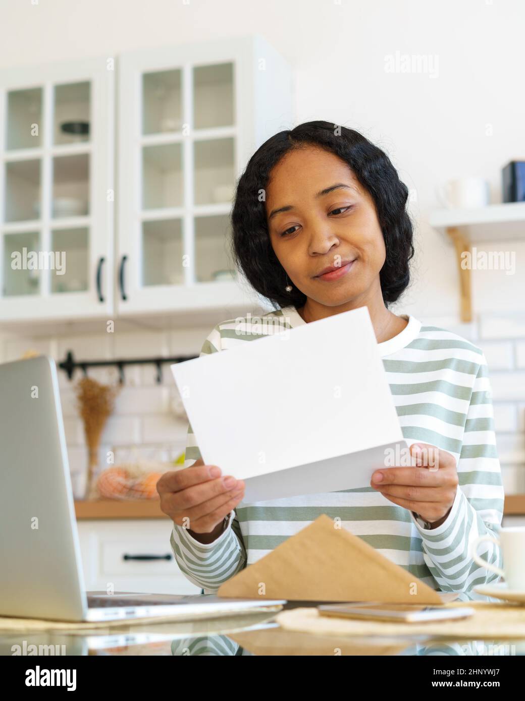 Young african-american female opening and reading letter. Concept of ...