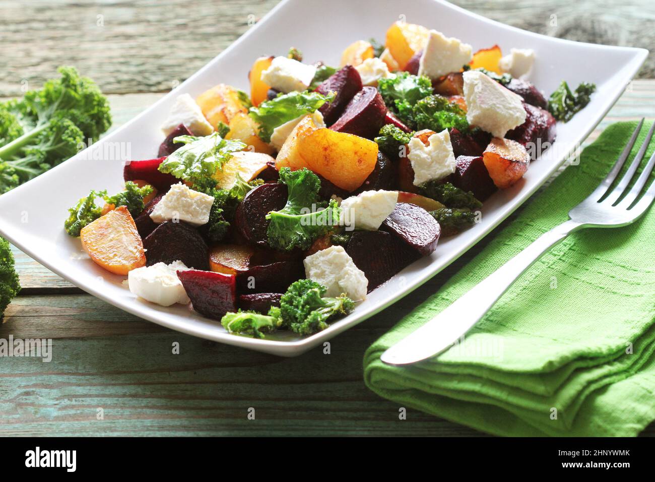 Fresh beet salad with feta cheese and fried cabbage kale Stock Photo ...